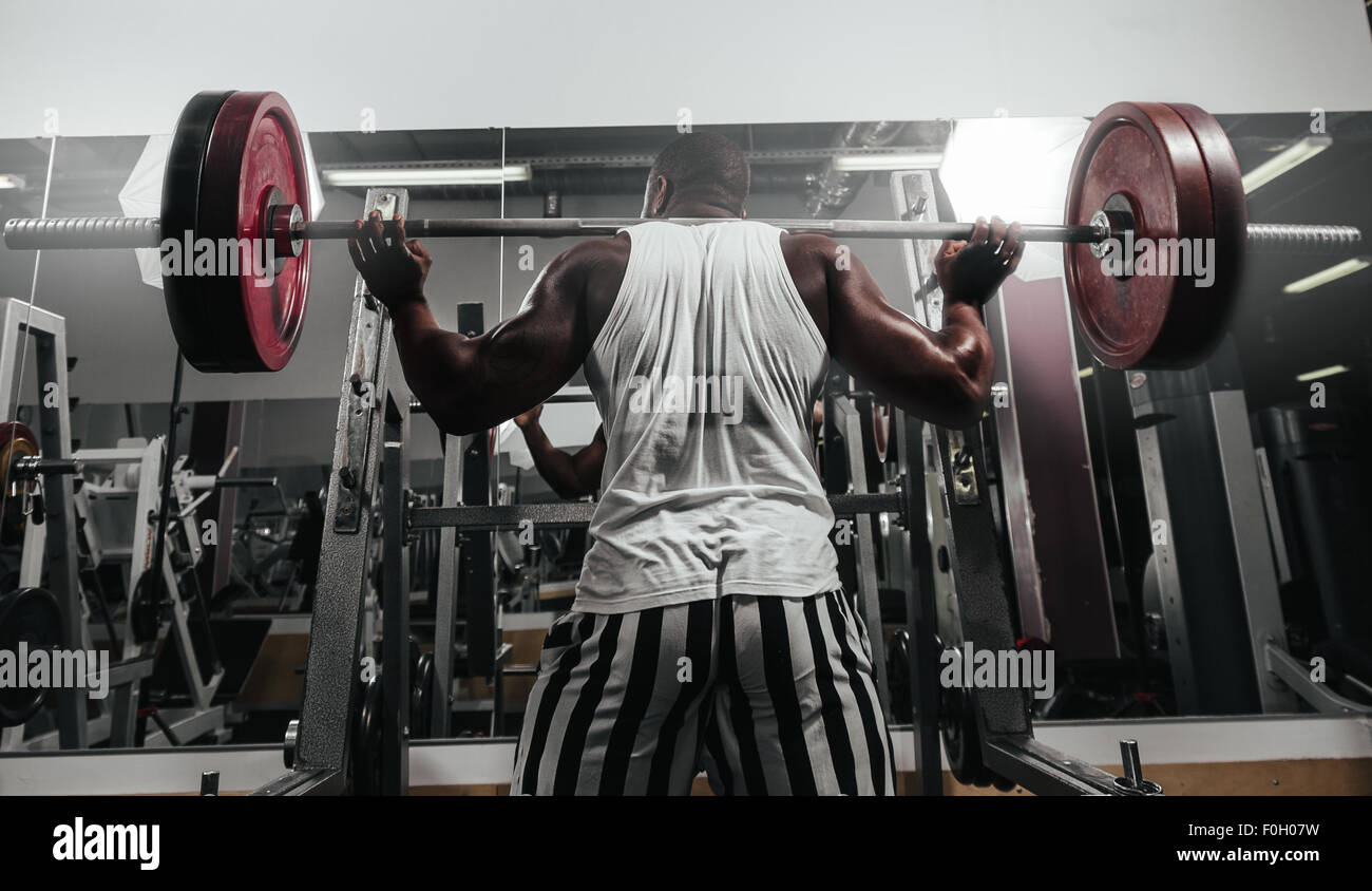 Weight training African doing bodybuilding in gym Stock Photo - Alamy