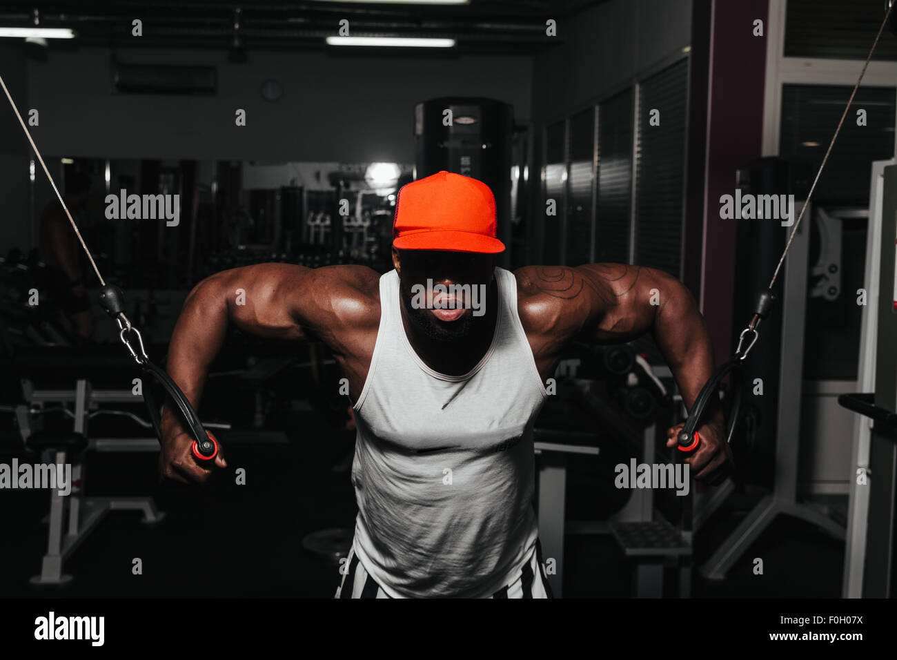 Weight training African doing bodybuilding in gym Stock Photo - Alamy