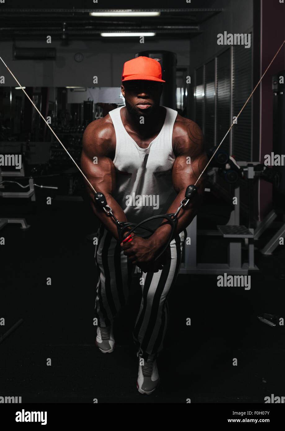 Weight training African doing bodybuilding in gym Stock Photo - Alamy