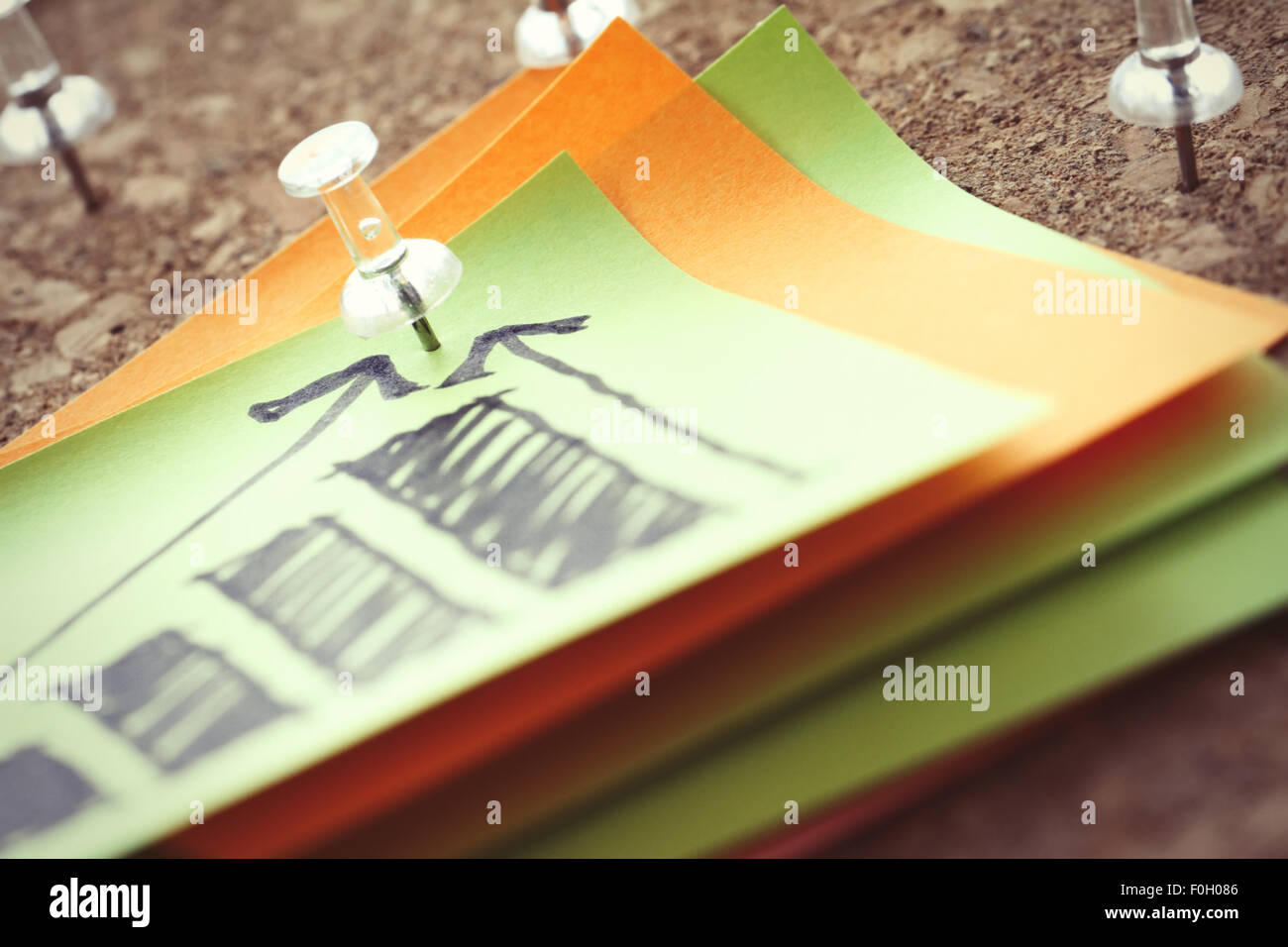 close up of pin and hand drawn business strategy graph chart on sticky ...