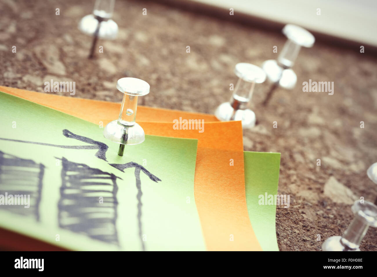 close up of pin and hand drawn business strategy graph chart on sticky ...