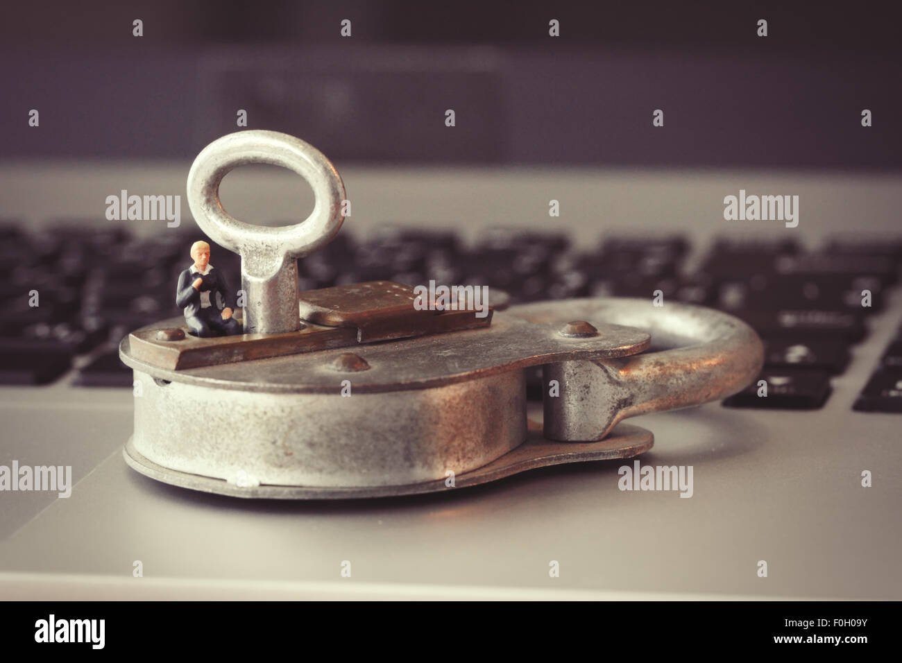 Internet security concept-old padlock and key on laptop computer ...