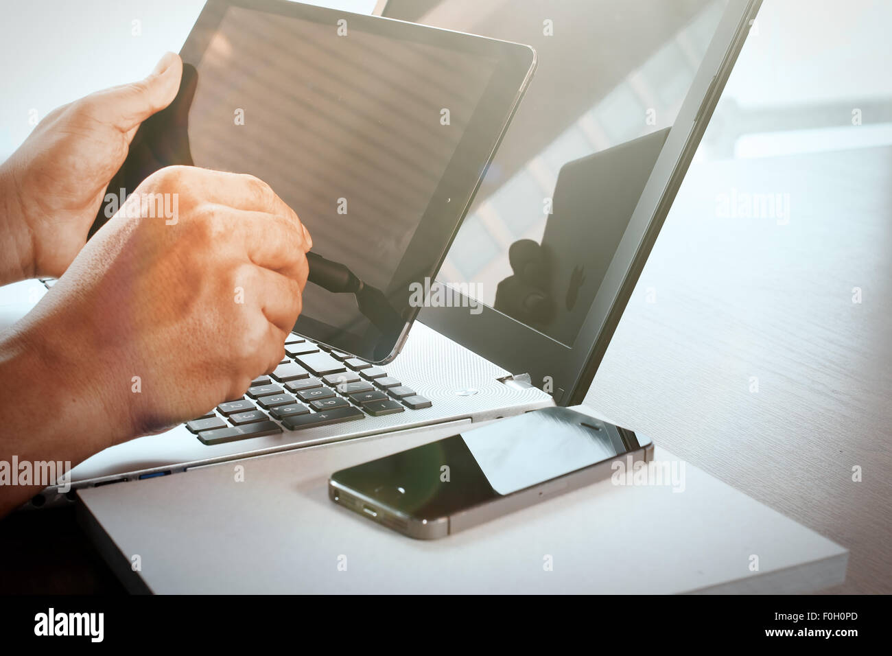 Young creative designer man working with stylus pen and digital tablet ...
