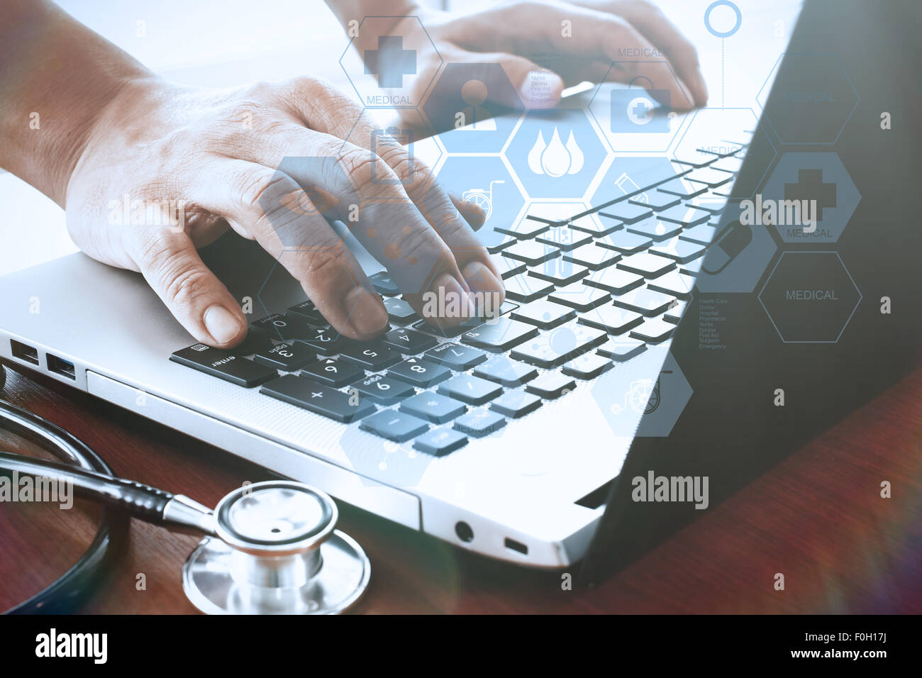 Doctor hand working with laptop computer in medical workspace office as ...