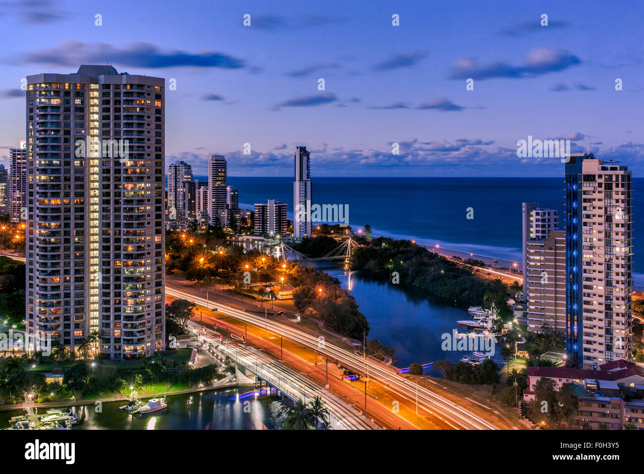 Night landscape showing high rise buildings next to the beach and ocean ...