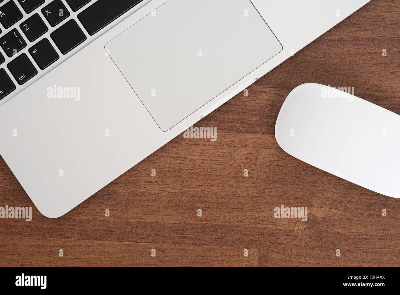 Laptop computer and mouse on a wooden desk, top view copy space Stock ...