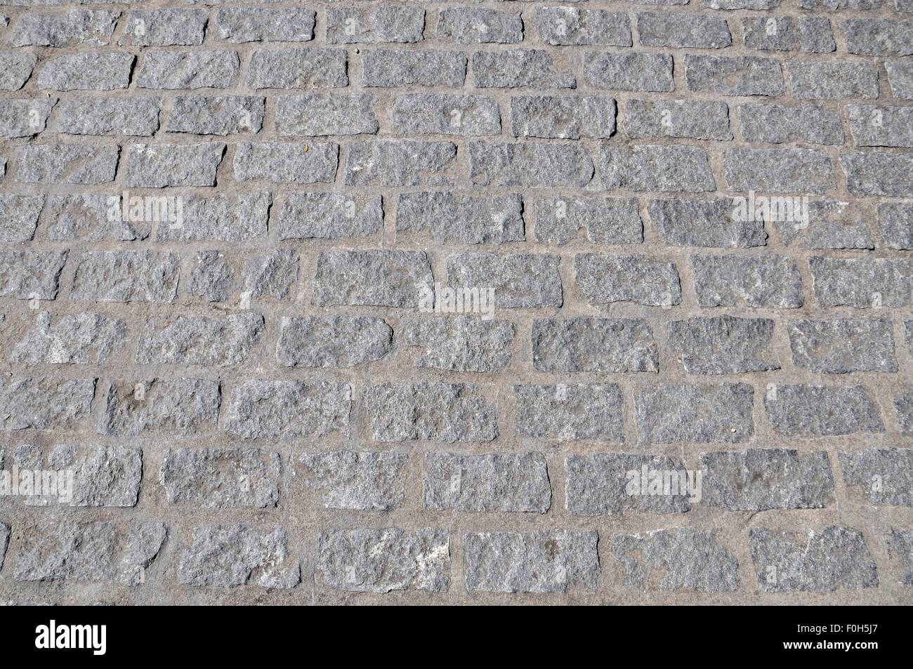 Grey cobbled brick paving background Stock Photo - Alamy