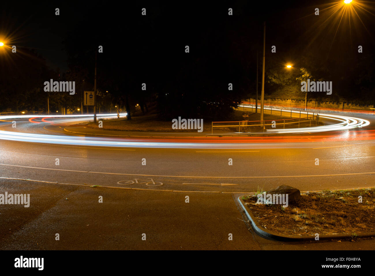 Cars driving a corner Stock Photo - Alamy