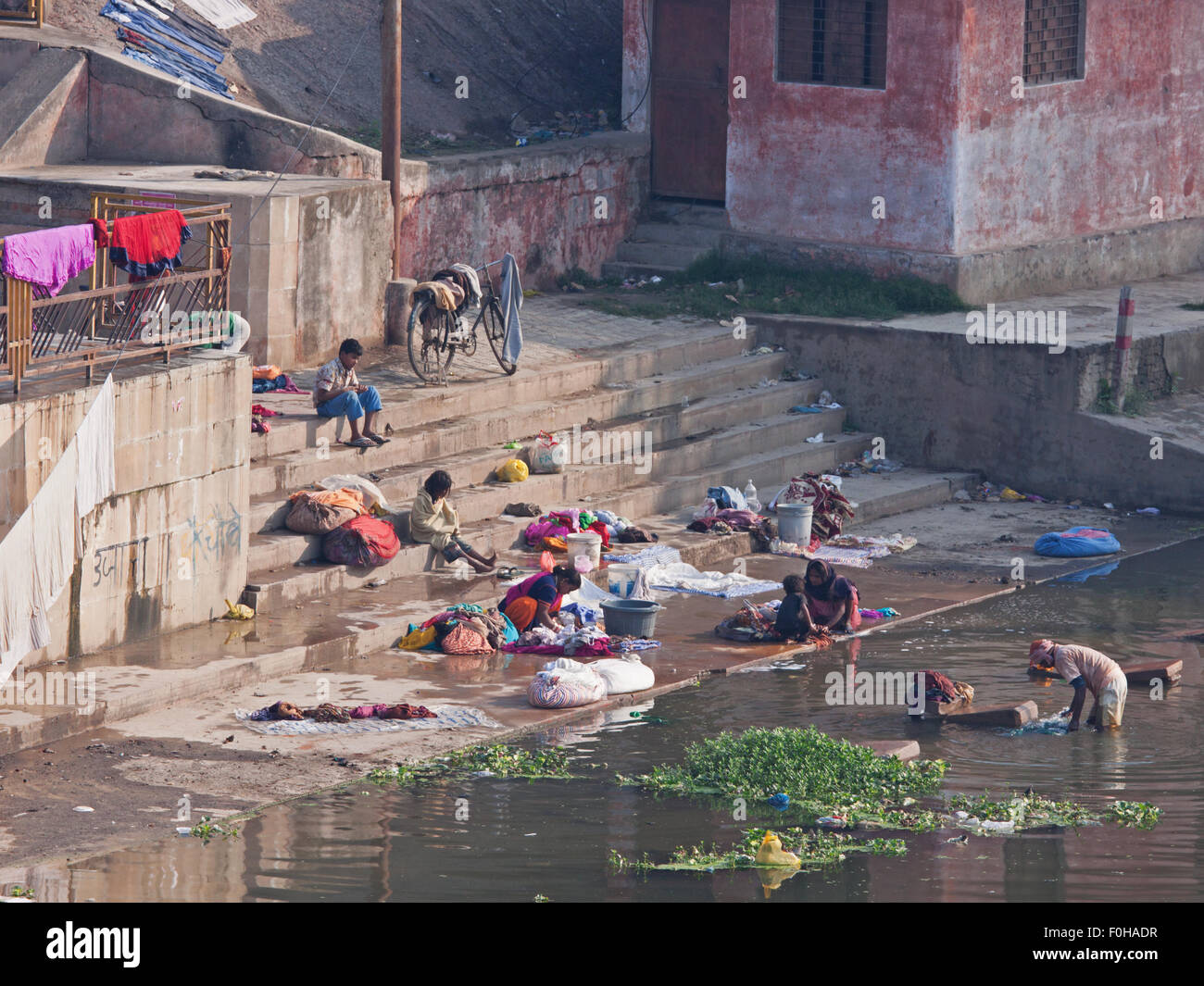 People washing clothes at a ghat on the Varuna river, common practice ...