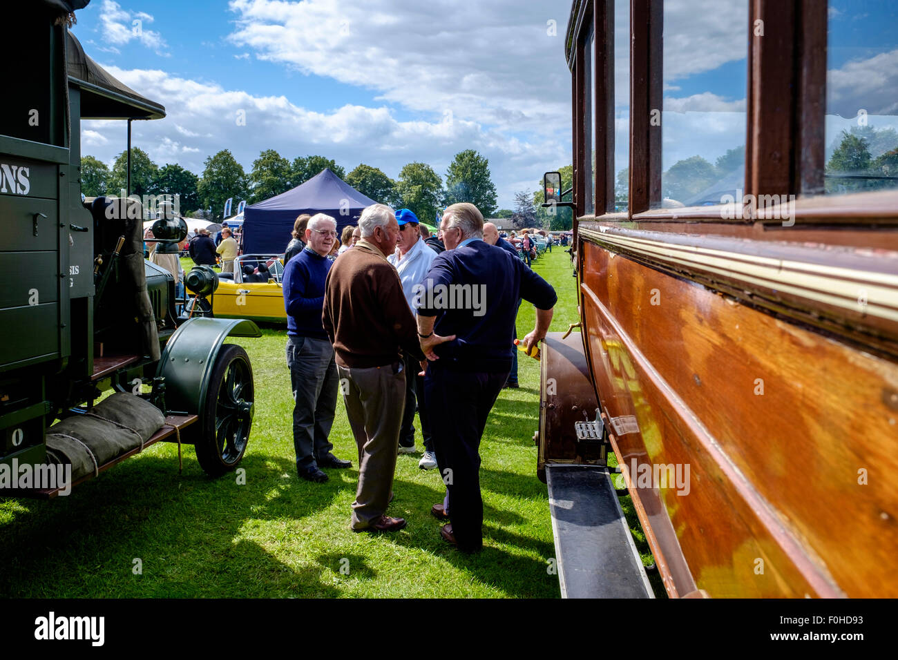 A group of gentlemen beside old buses at the Biggar Vintage Rally ...