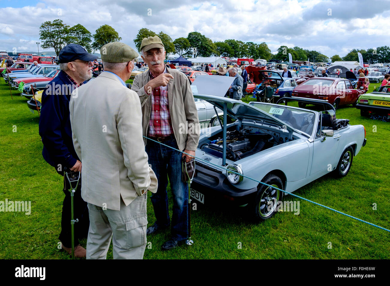 Three gentlemen discussing cars at the Biggar Vintage Rally, South ...