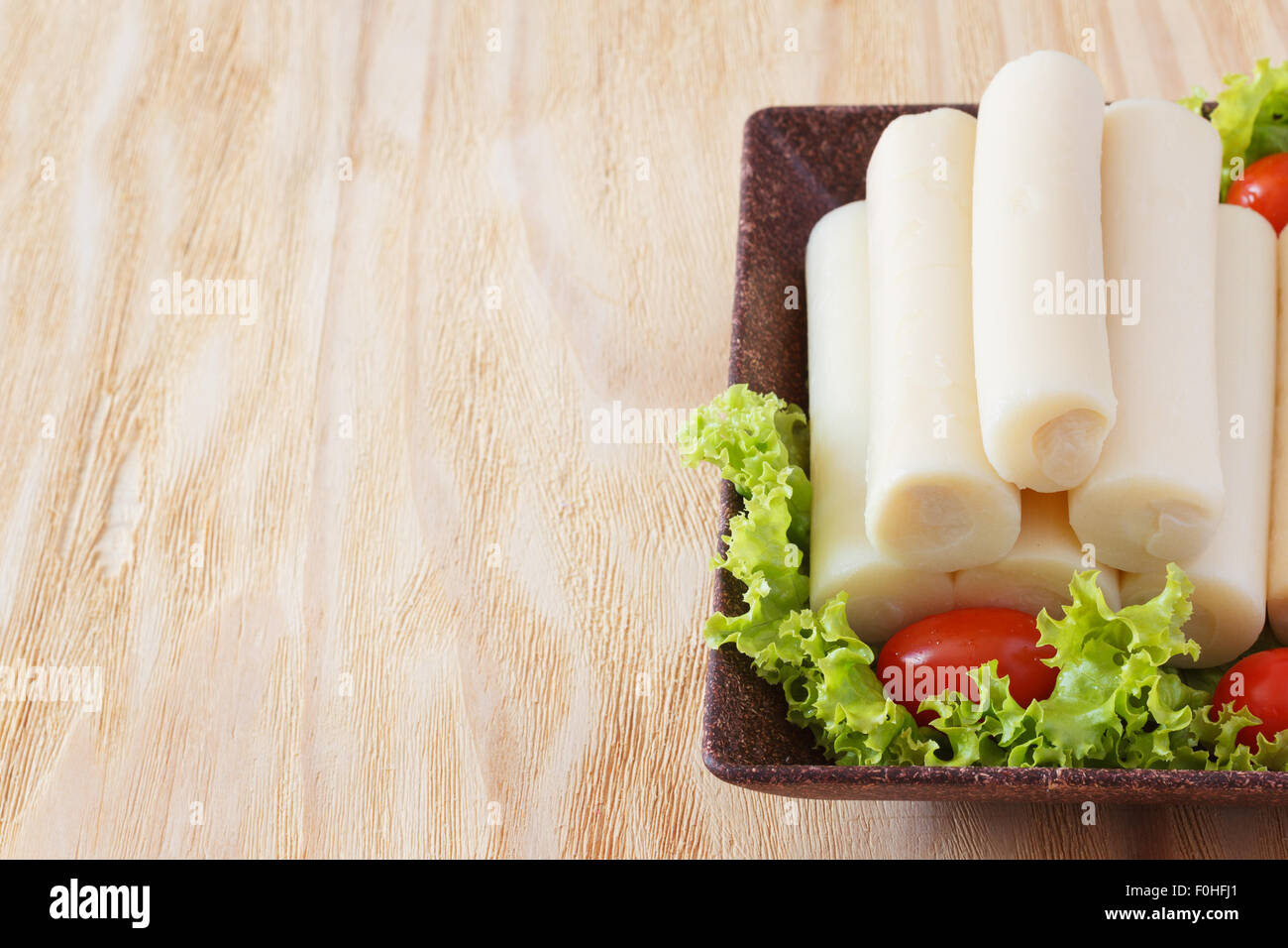 Heart of palm (palmito) with cherry tomato on plate. Selective focus ...