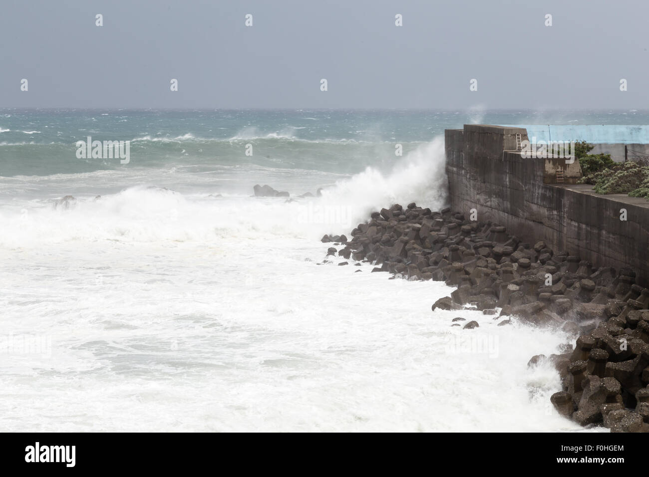 Stormy sea during Typhoon Souledor. waves crashing on barrier wall ...