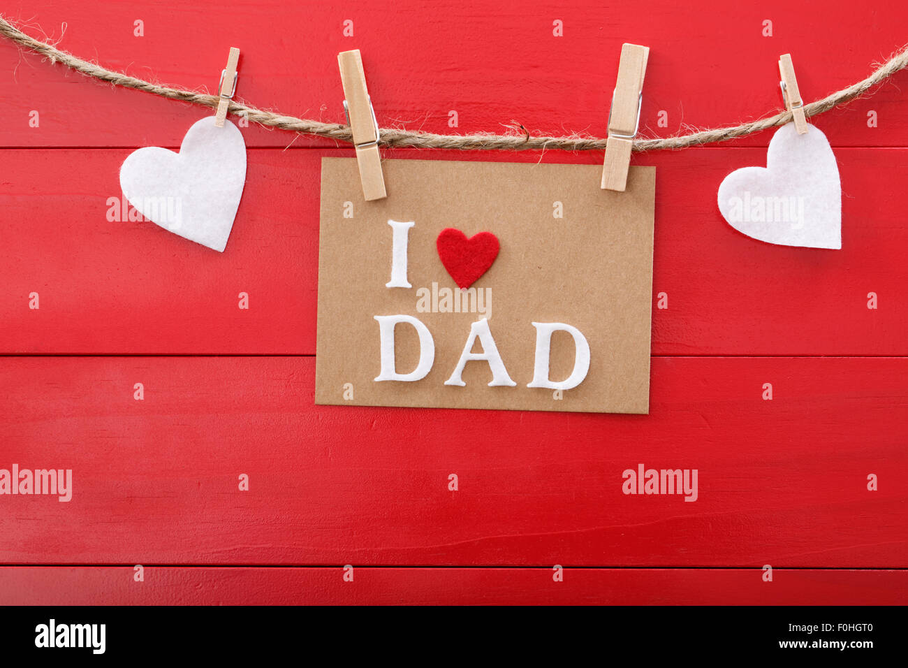 Fathers day message with felt hearts hanging with clothespins over red ...