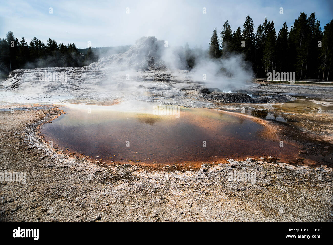 Landscape with colorful pool and geyser, Yellowstone National Park ...