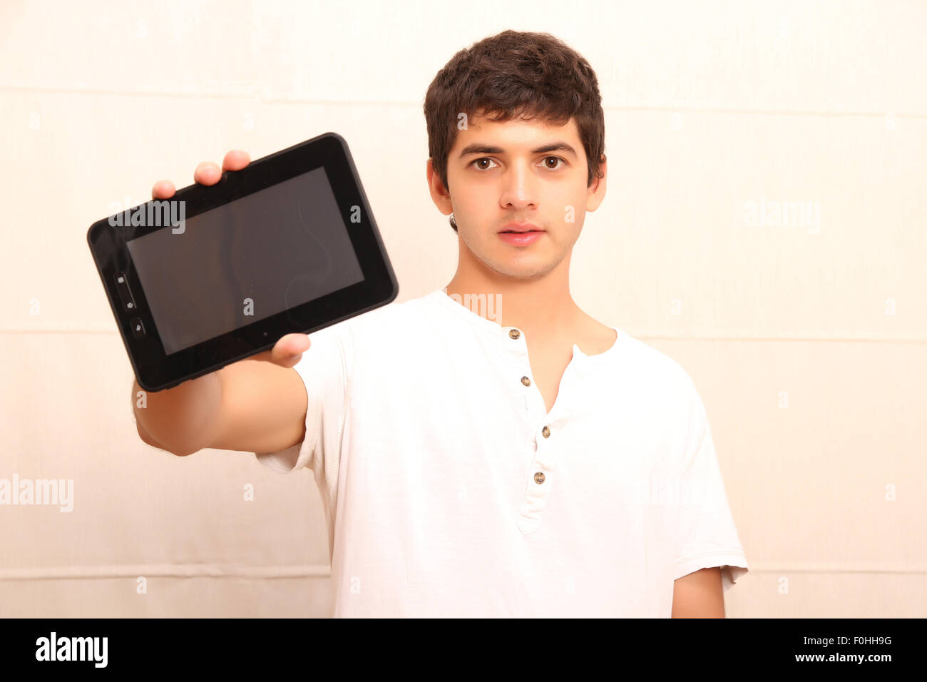 A young, latin man with a Tablet PC, face in focus Stock Photo - Alamy