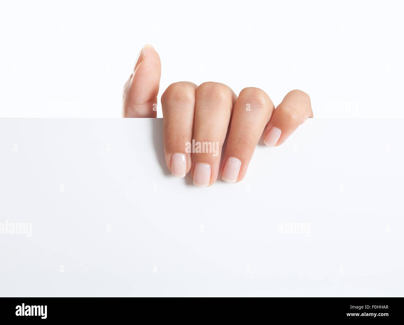 Woman's hand holding a sign in front of a white background, isolated ...