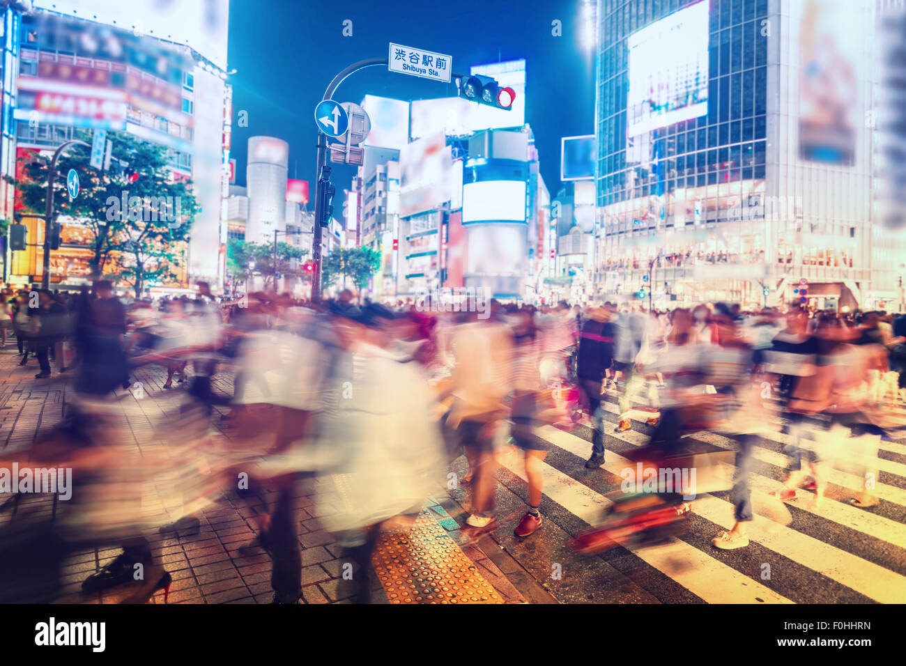 People and vehicles cross the famously busy Shibuya station ...