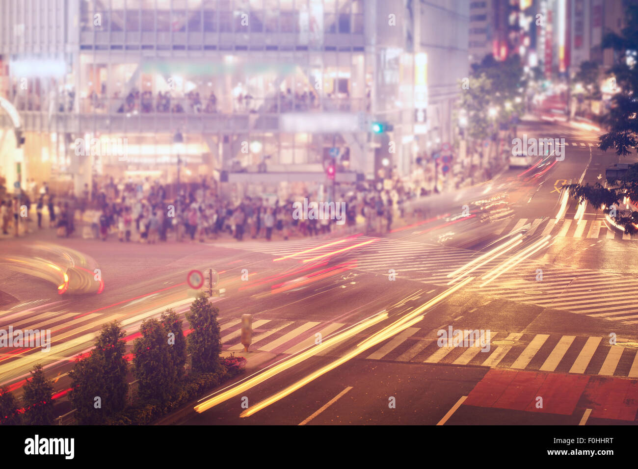 People and vehicles cross the famously busy Shibuya intersection in ...