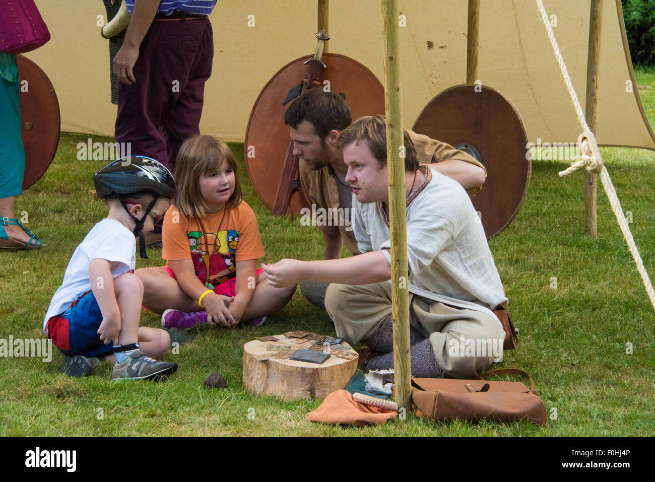Anglo Saxon and Viking re-enactment man doing a demonstration for young ...