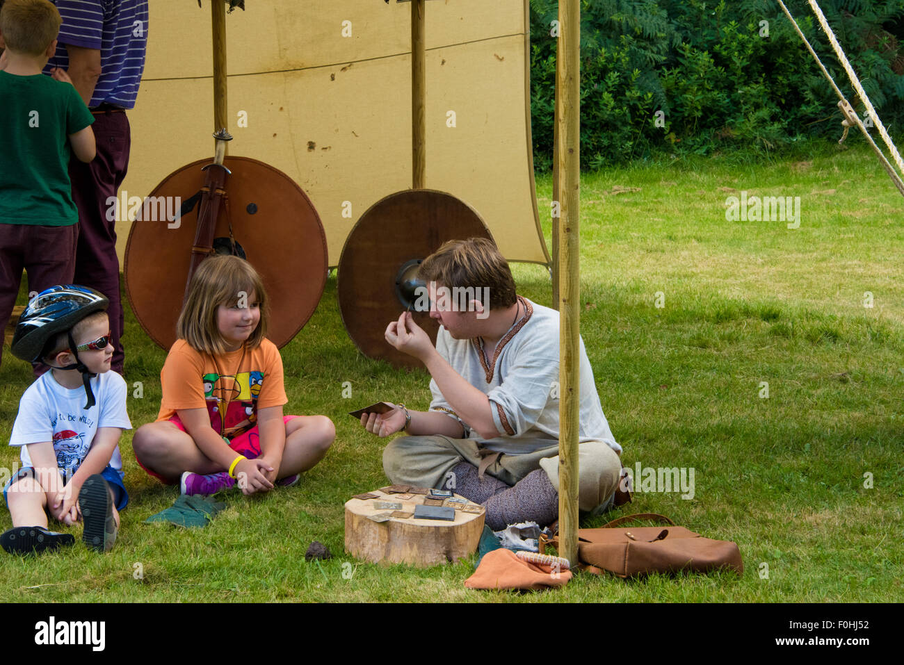 Anglo Saxon and Viking re-enactment man doing a demonstration for young ...