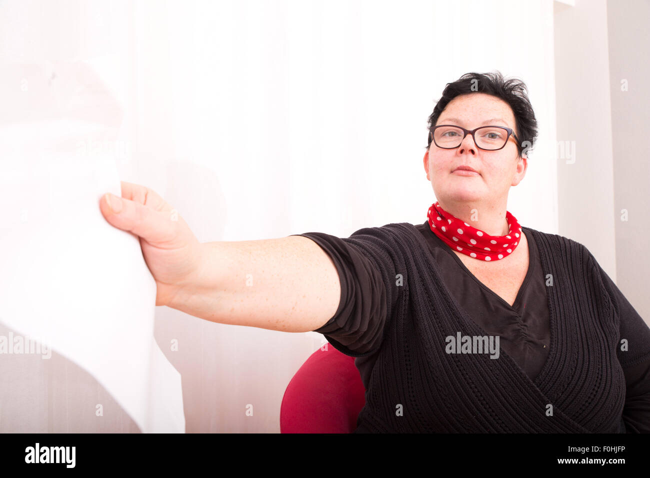 A woman handing over some documents Stock Photo - Alamy