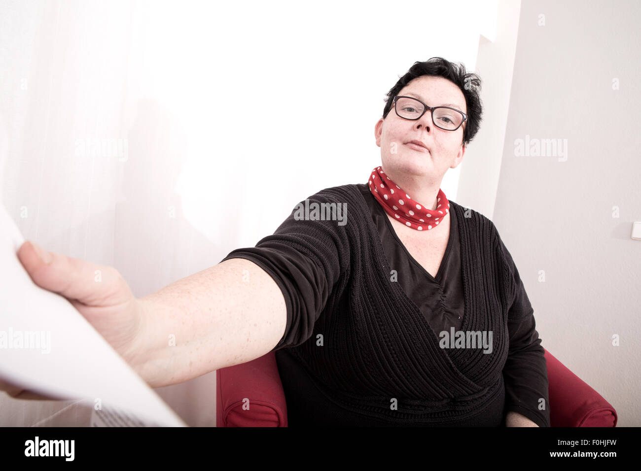 A woman handing over some documents Stock Photo - Alamy