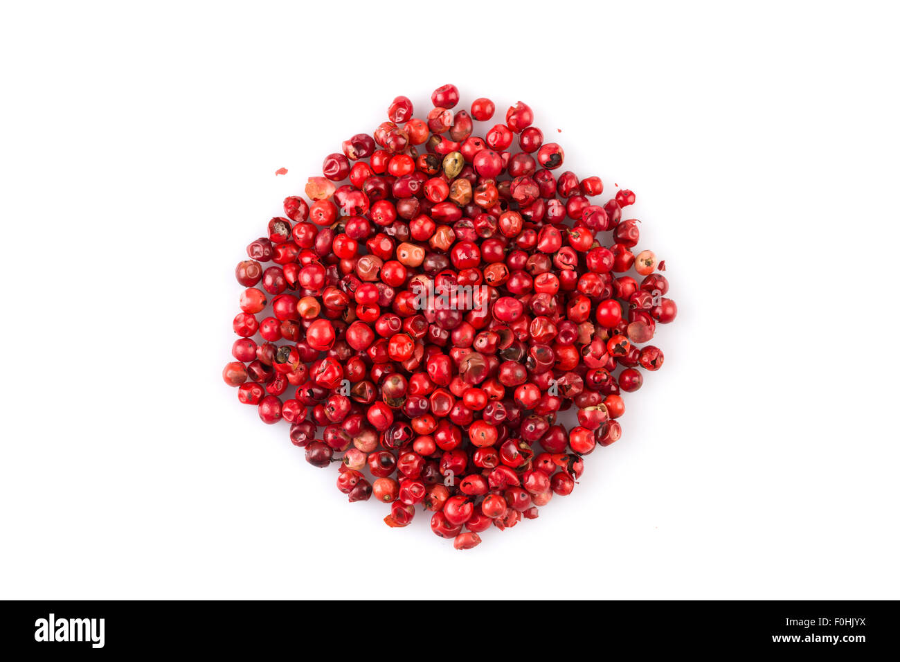 red peppercorns seeds isolated on white background Stock Photo - Alamy