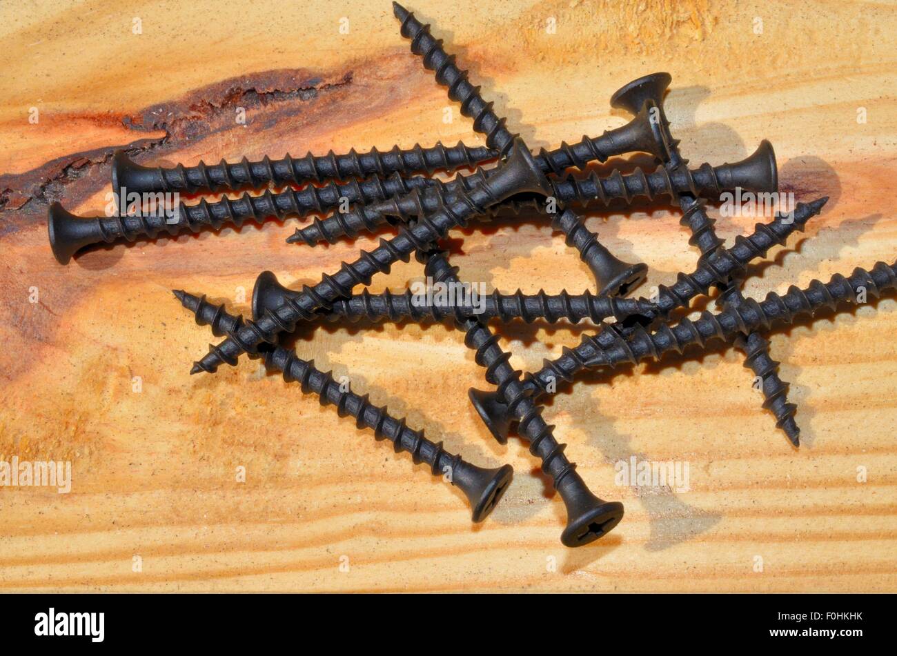 Black building screws set on wood Stock Photo - Alamy