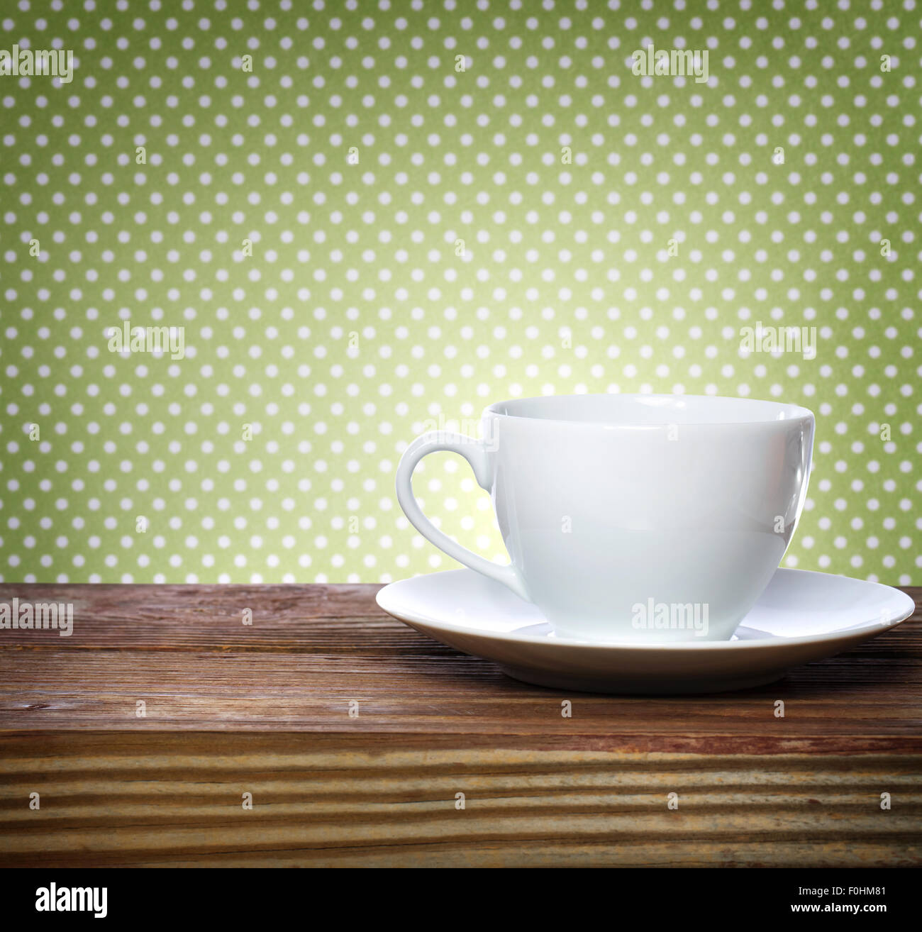 Coffee cup over green polka dots background Stock Photo - Alamy