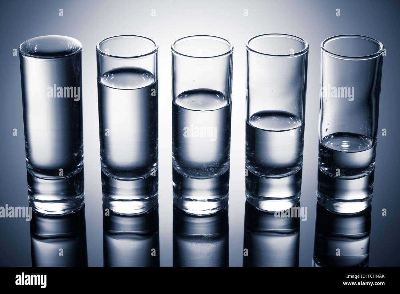 row of glasses for vodka Stock Photo - Alamy