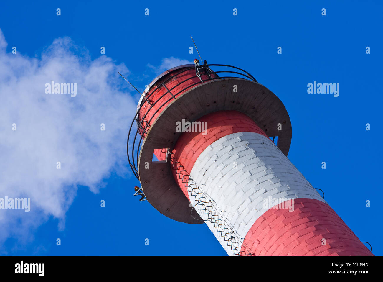 Big smokestack detail against blue sky Stock Photo - Alamy