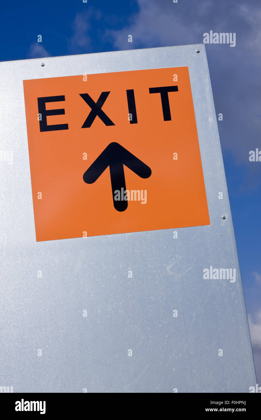 Orange exit sign against the blue sky Stock Photo - Alamy