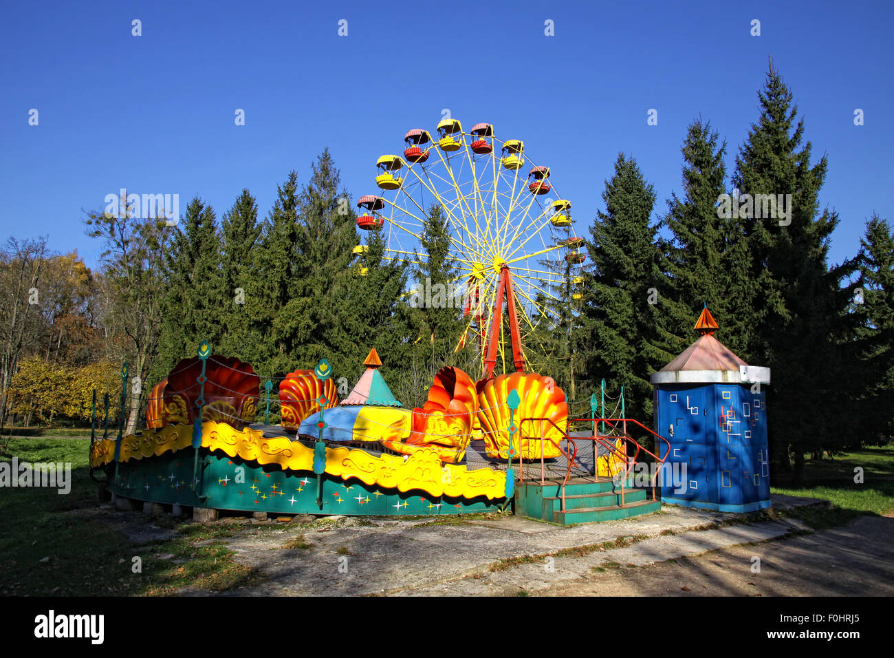 Vintage Merry-Go-Round and Ferris wheel in an amusement park Stock ...