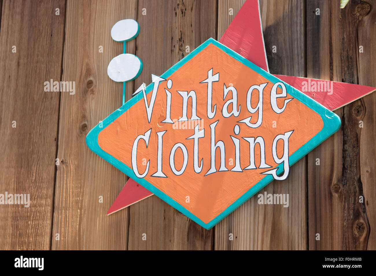 colorful vintage clothing sign on a wood siding building in the Mojave ...