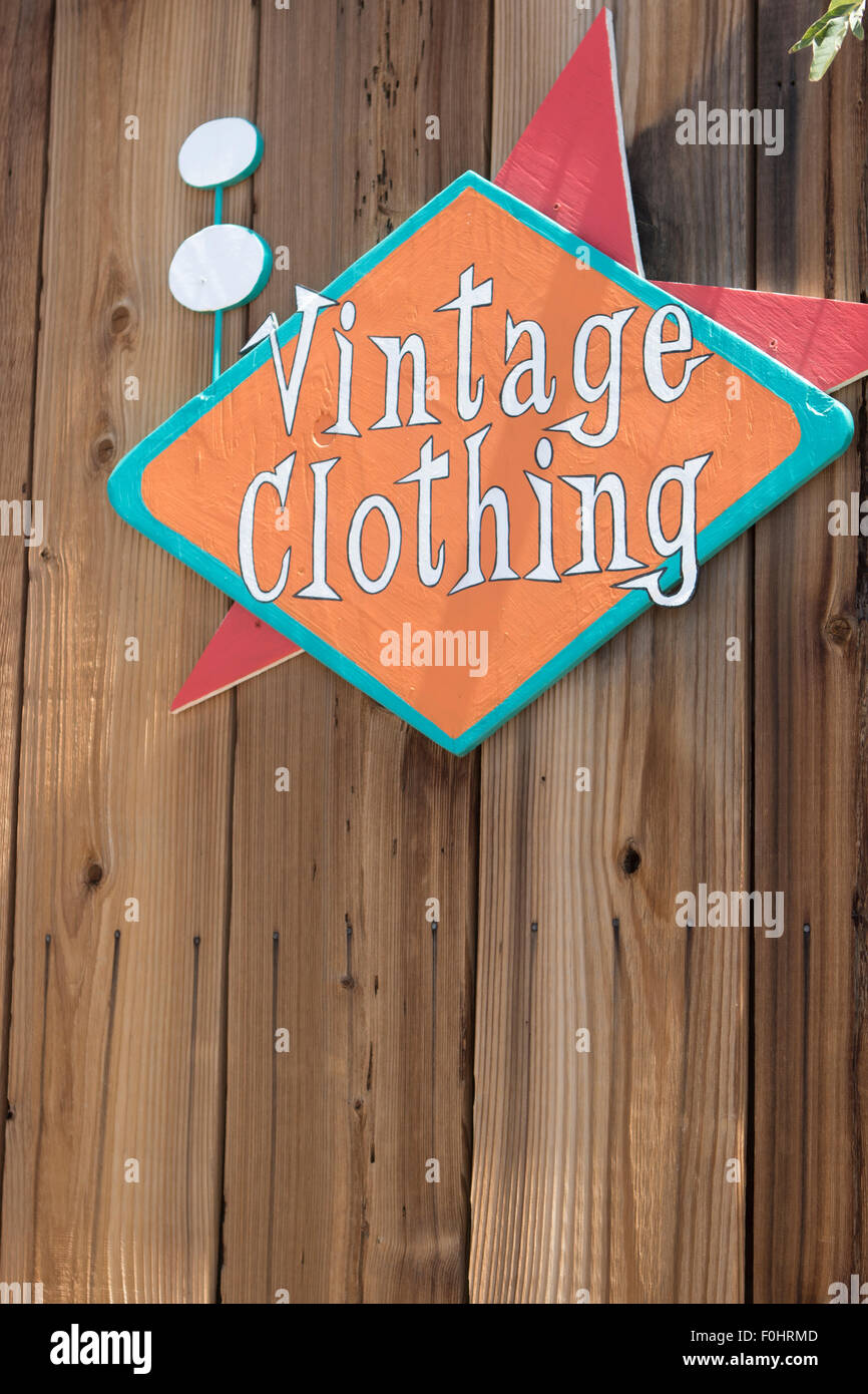 colorful vintage clothing sign on a wood siding building in the Mojave ...