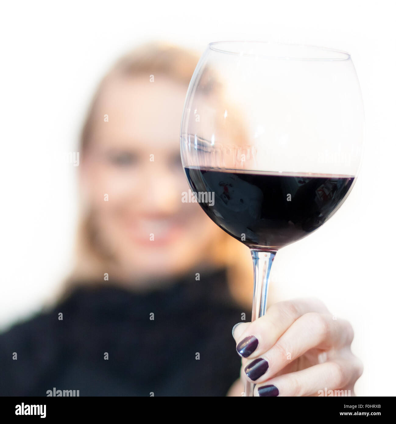 Toasting with a glass of red wine Stock Photo - Alamy