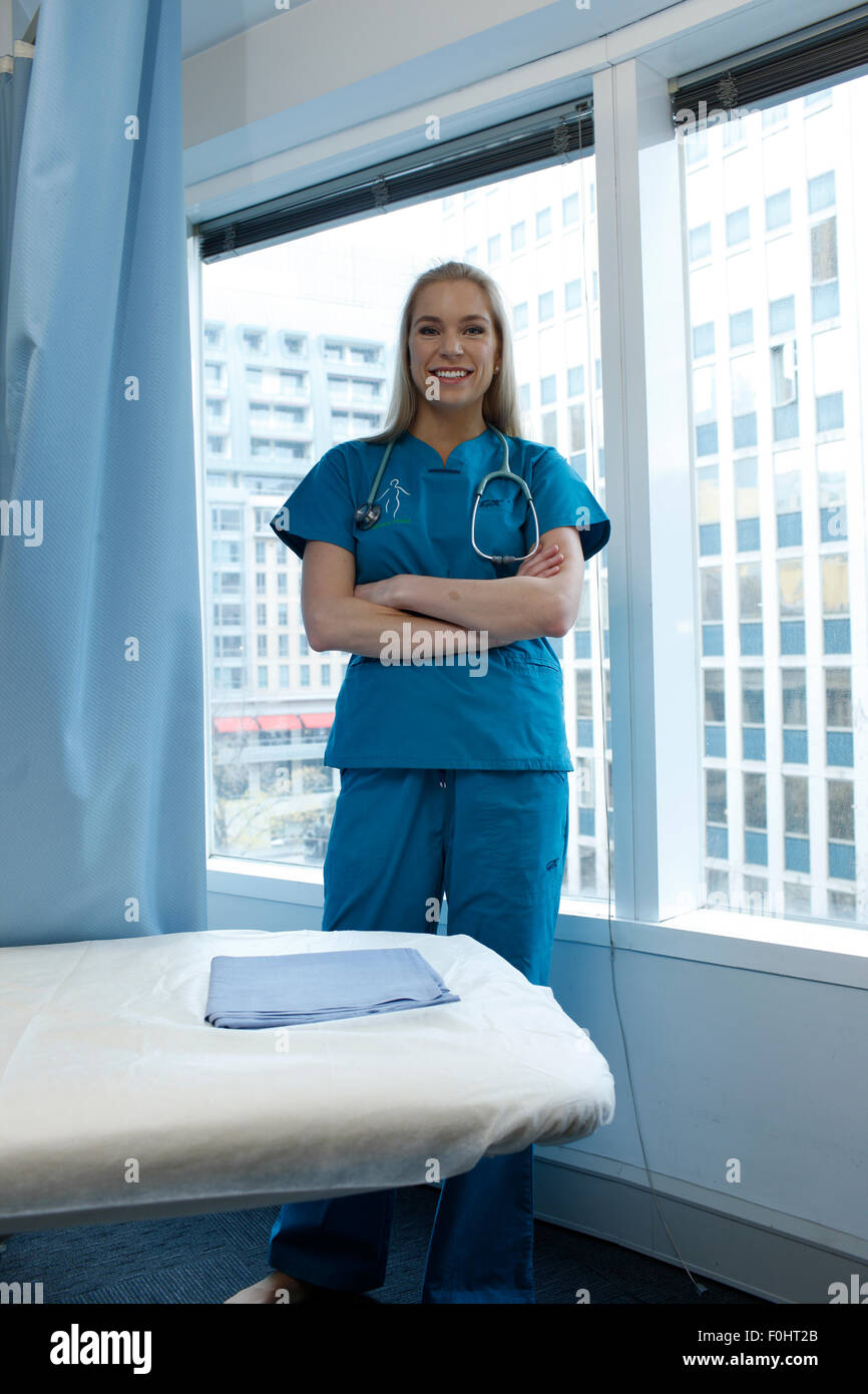 A young female doctor awaits her patient in her surgery Stock Photo - Alamy