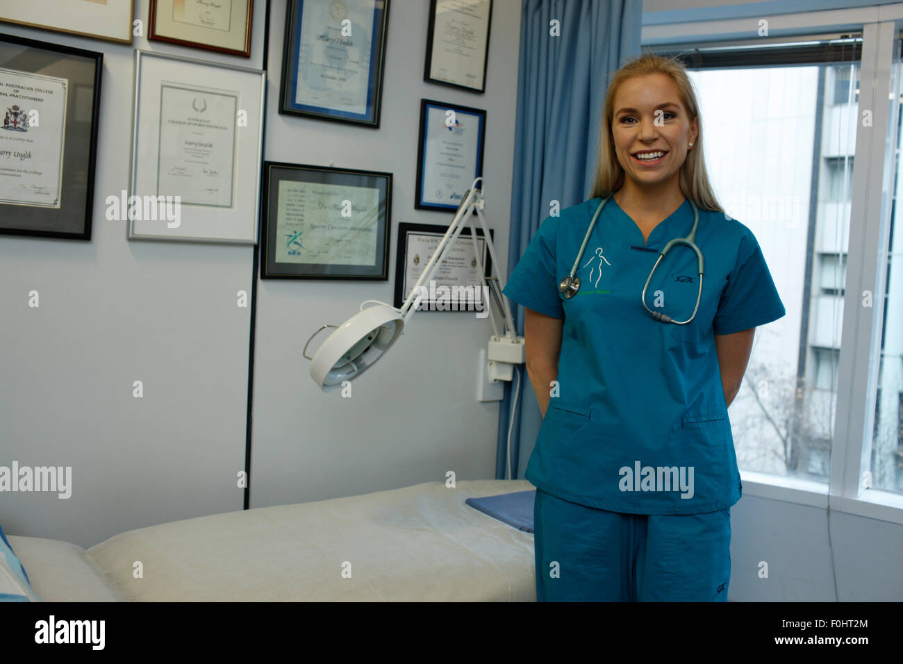 A young female doctor awaits her patient in her surgery Stock Photo - Alamy