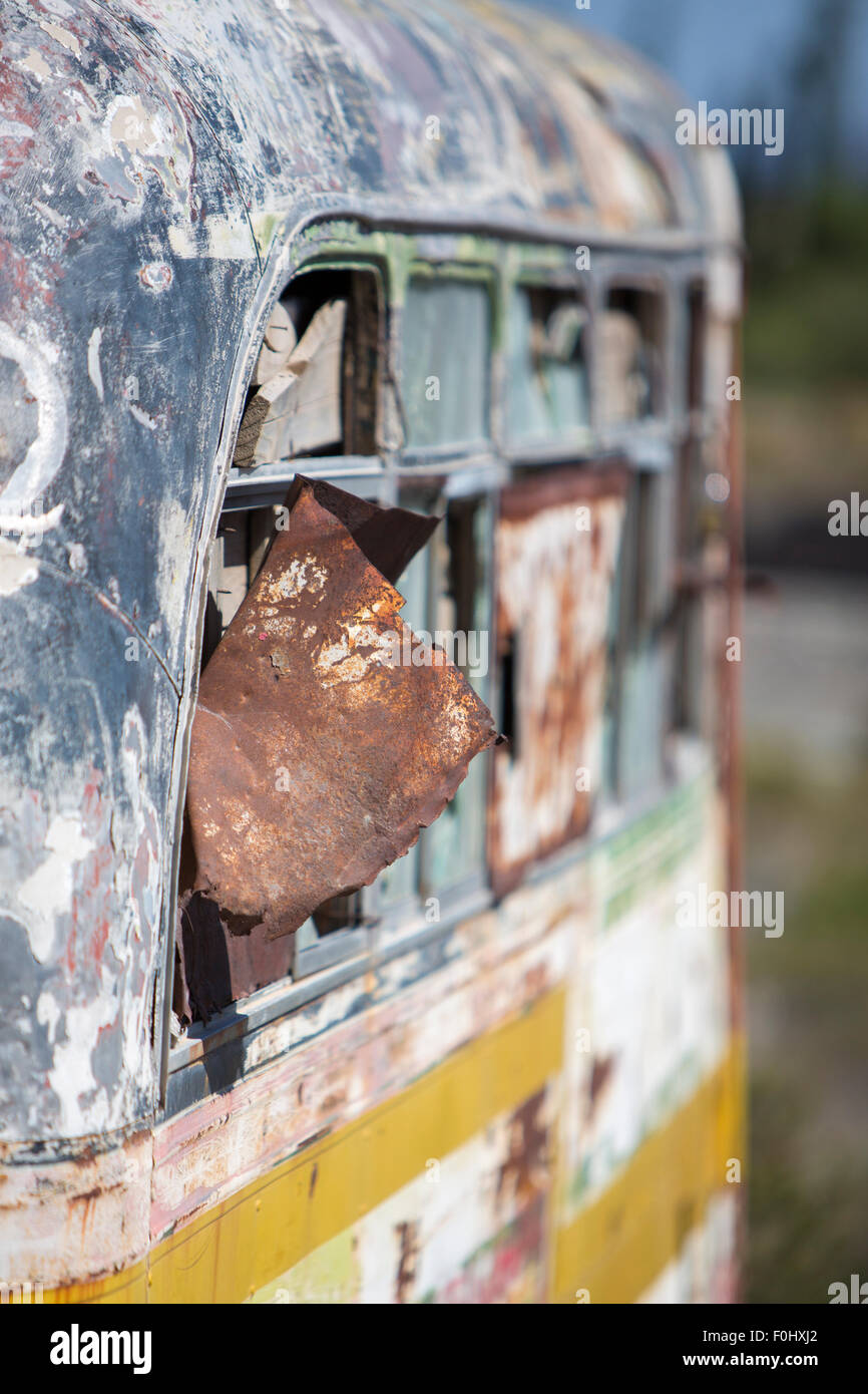 Detail of rusted old colored school bus with broken windows abandoned ...