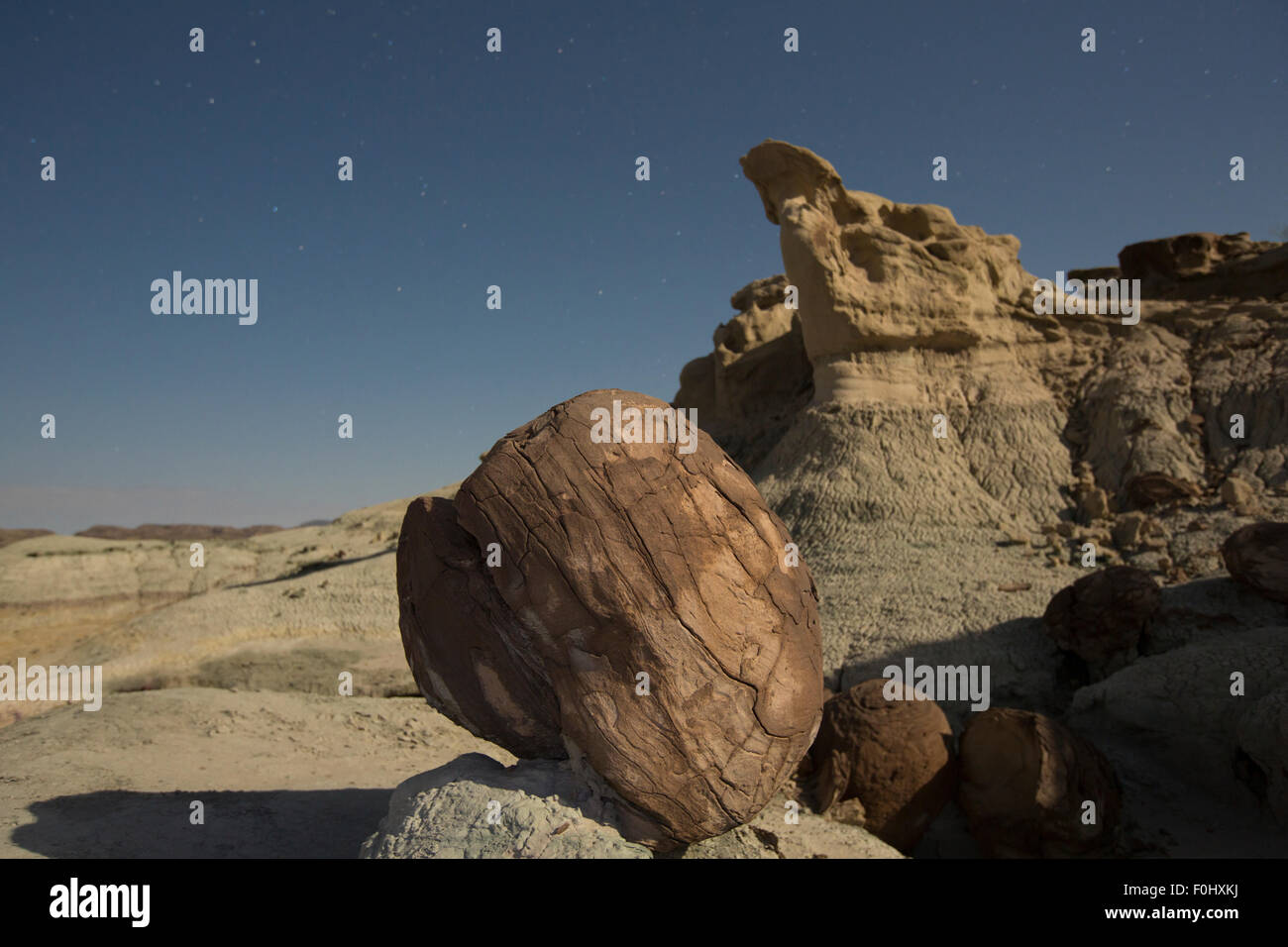 Unusual rock formation at night with full moon, Moon Valley (Valle de ...