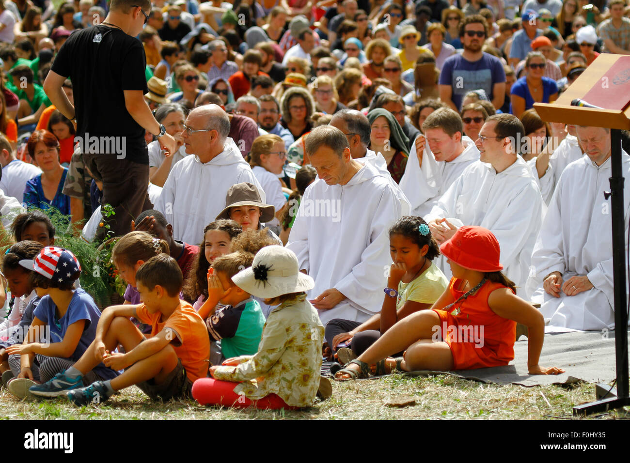 Burgundy, France. 16th Aug, 2015. The Brothers of Taizé sit in the ...