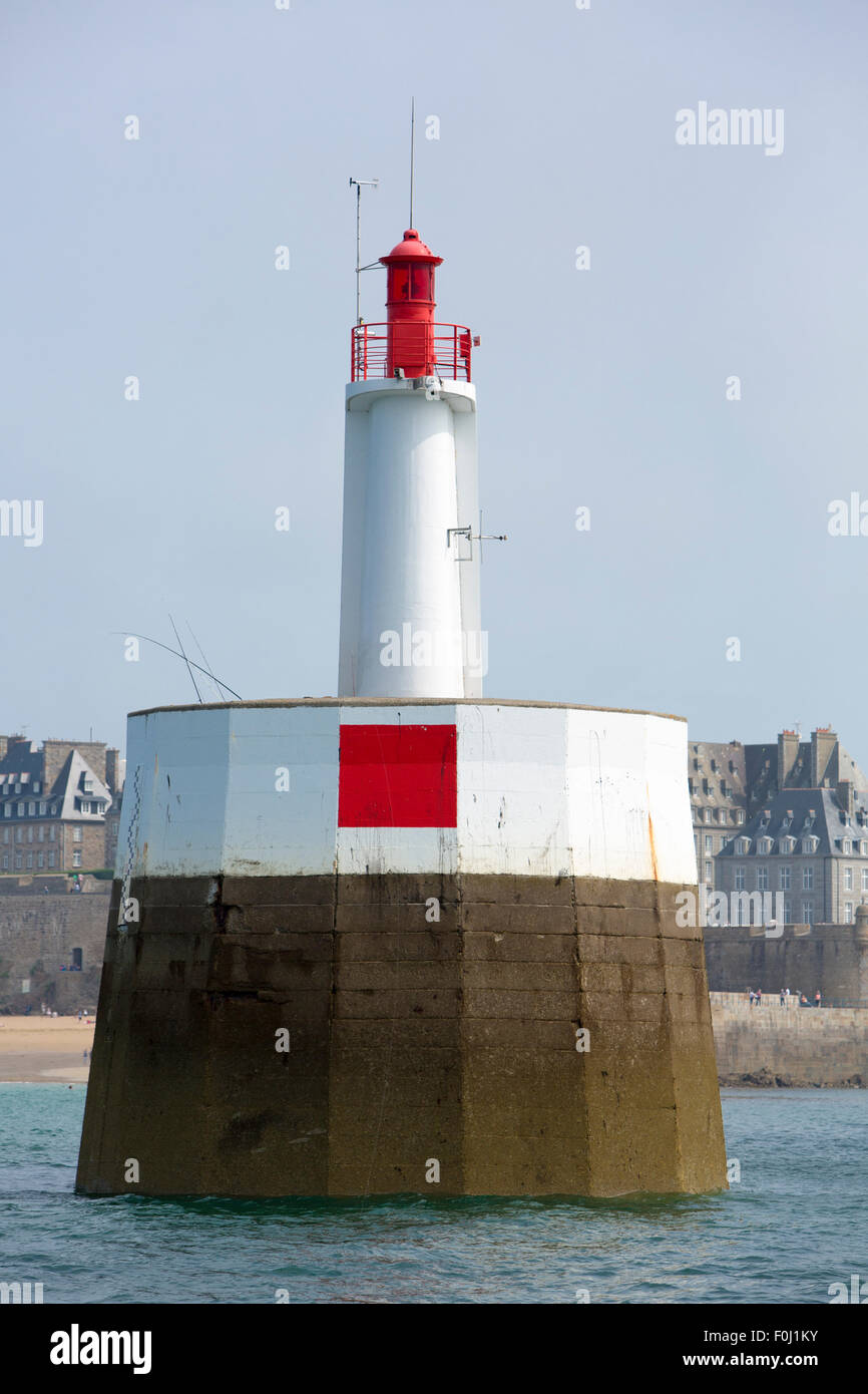 Lighthouse of St Malo with fisher men in action againts blue sky ...