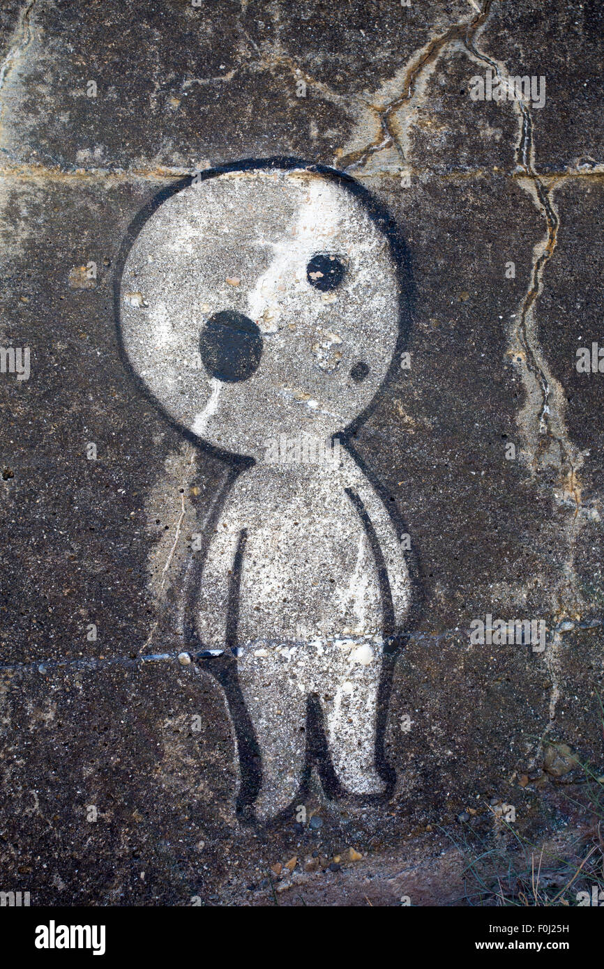 Alien character on concrete wall painted on the wall of an old German ...