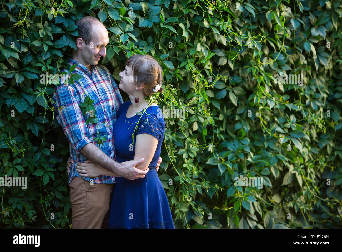 Young happy couple hugging outdoors among the greenery Stock Photo - Alamy Young happy couple hugging outdoors among the greenery Stock Photo - Alamy