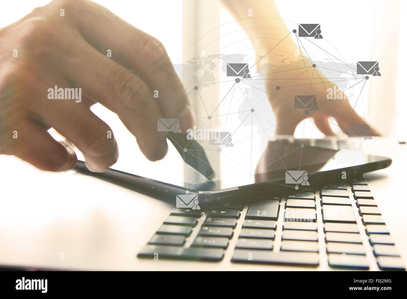 Businessman hand using laptop and digital tablet in office with social ...