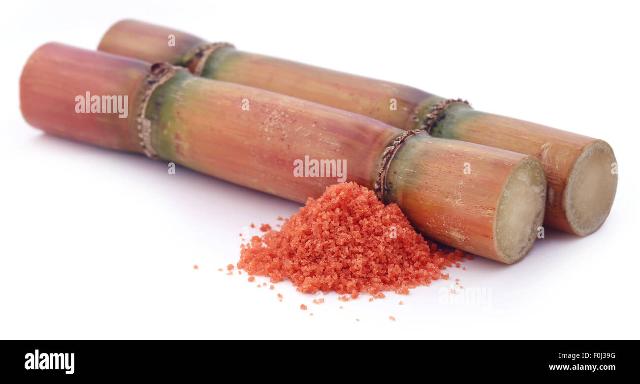 Piece of sugarcane with red sugar over white background Stock Photo - Alamy
