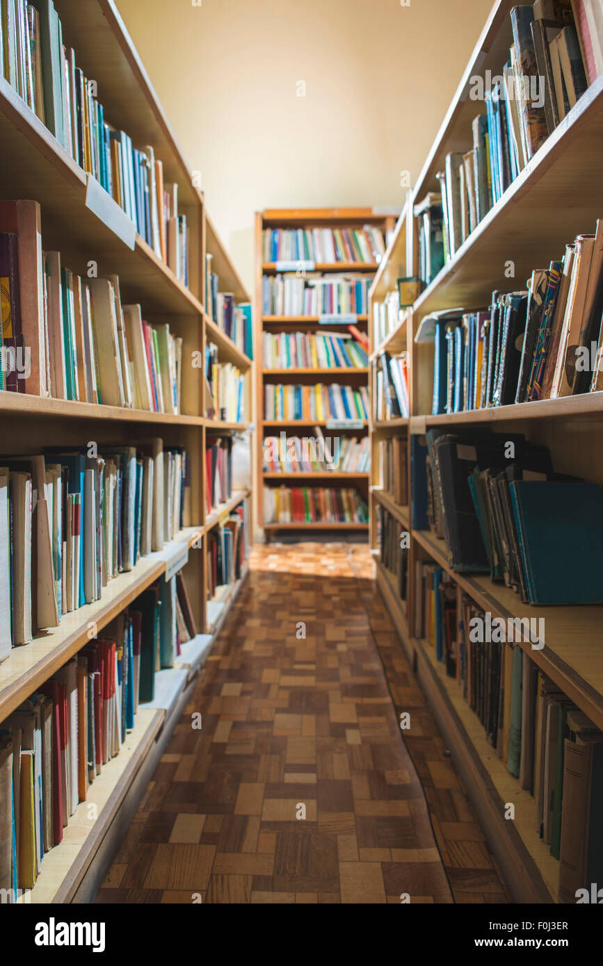 Old books in a vintage library shelfs Stock Photo - Alamy
