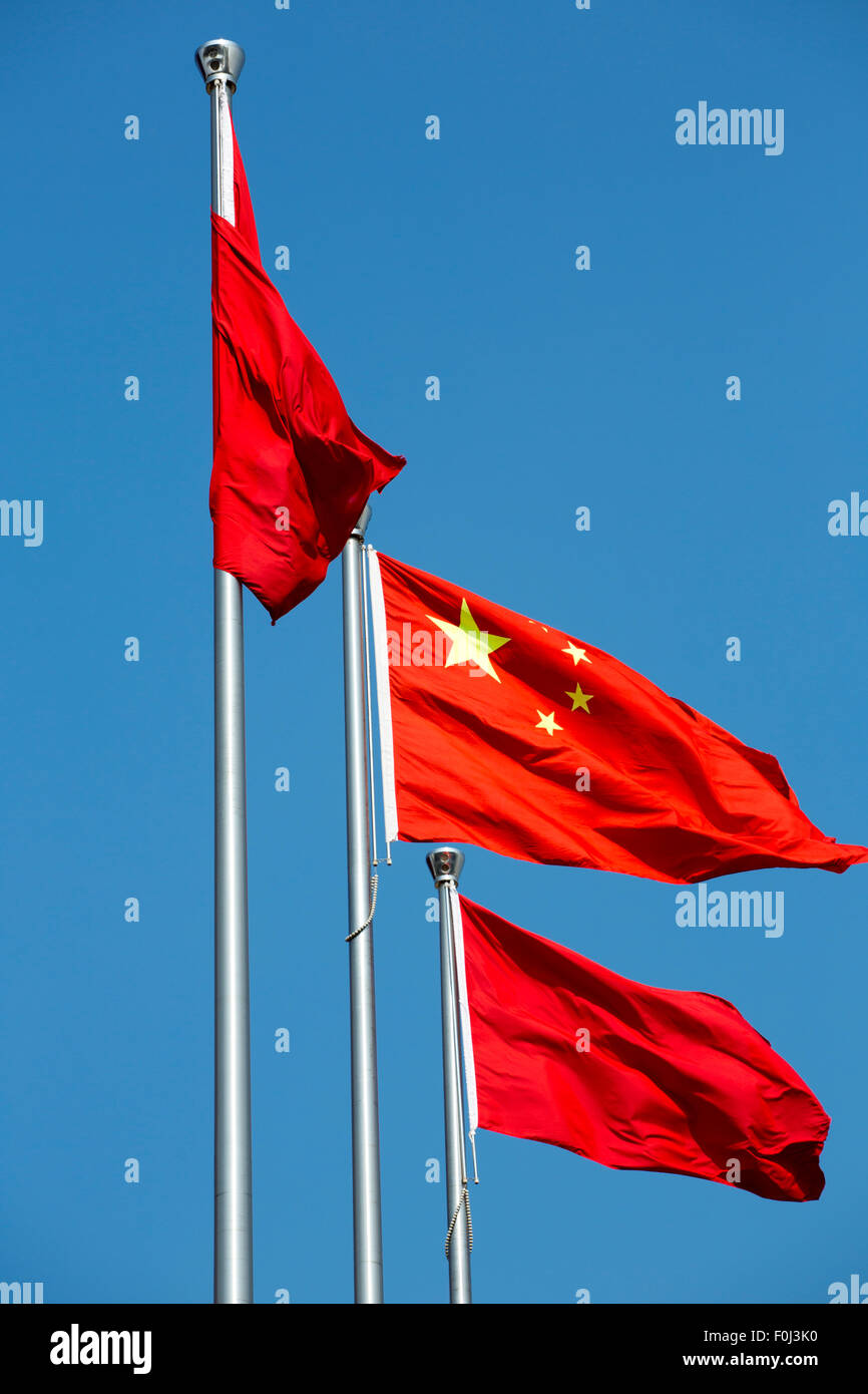 Three Chinese national flag within a blue sky, low angle photographs ...