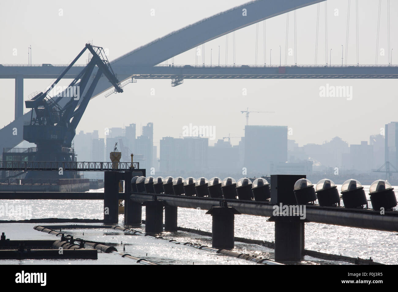 View of a massive bridge and the Shanghai harbor over the Huangpu River ...